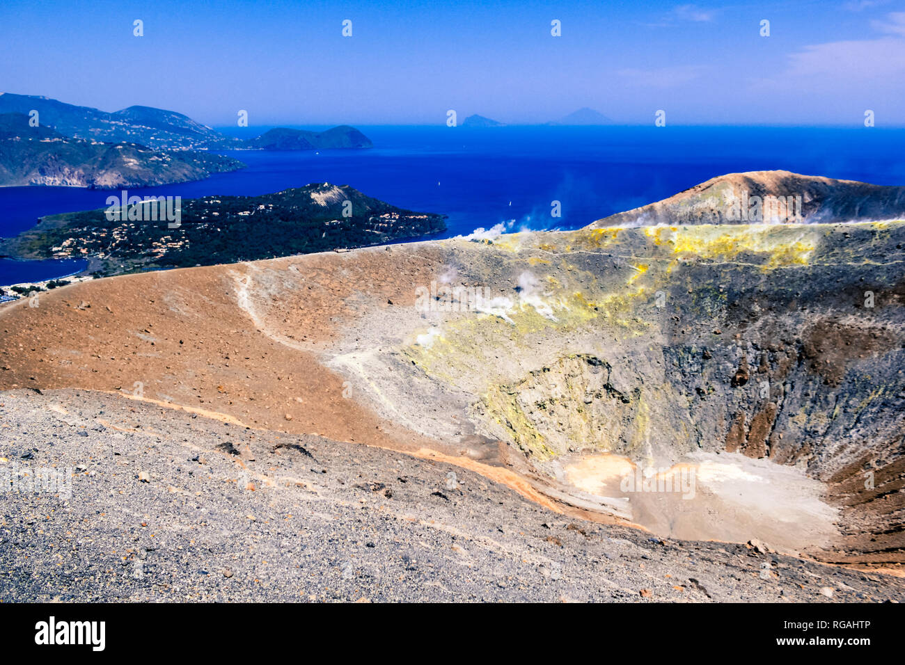 The crater of a volcano at Vulcano Island in Italy attracts tourists ...