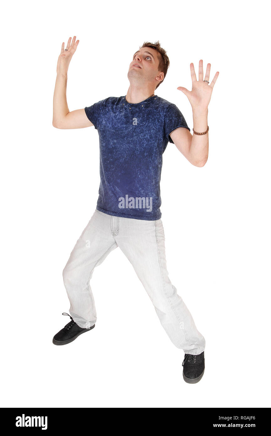 A friend young man standing with his hands up into the air and looking ...