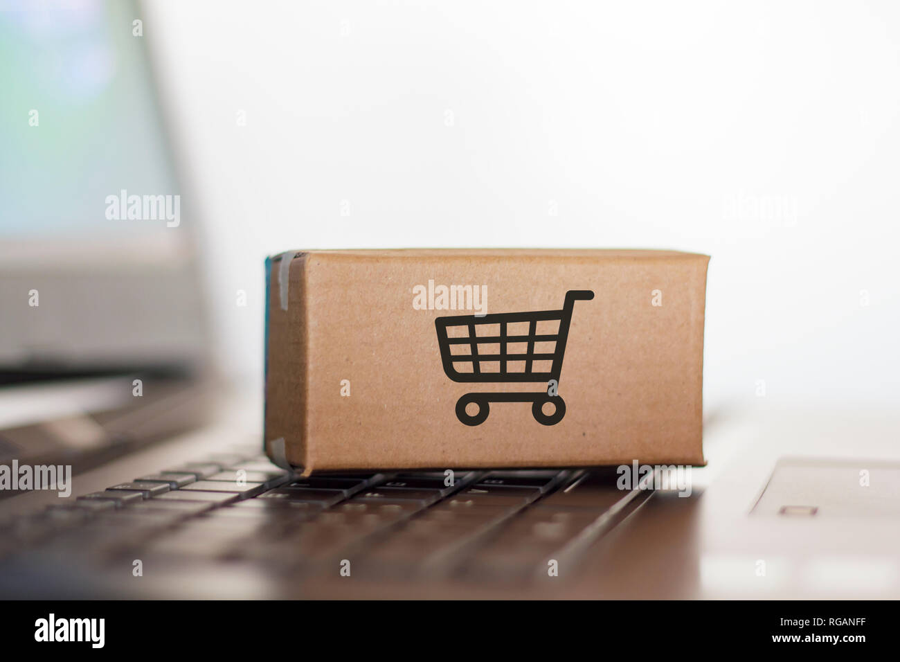 Carton on computer keyboard. Online shopping, e-commerce and worldwide ...