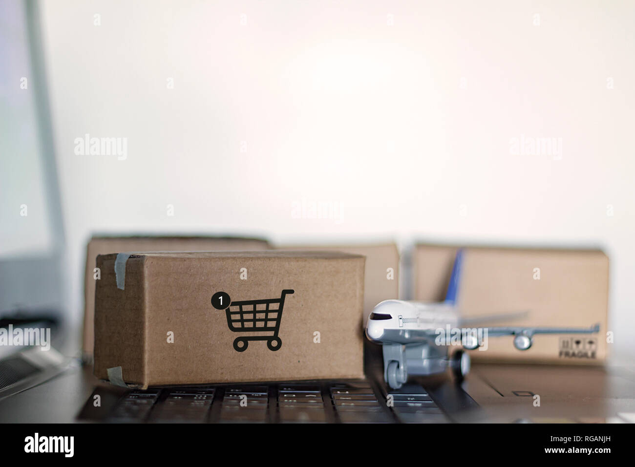 Cartons and airplane on computer. Online Shopping and worldwide ...