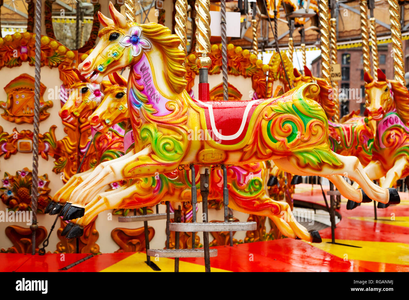 A brightly painted wooden horse on a carousel. Carousels are often ...