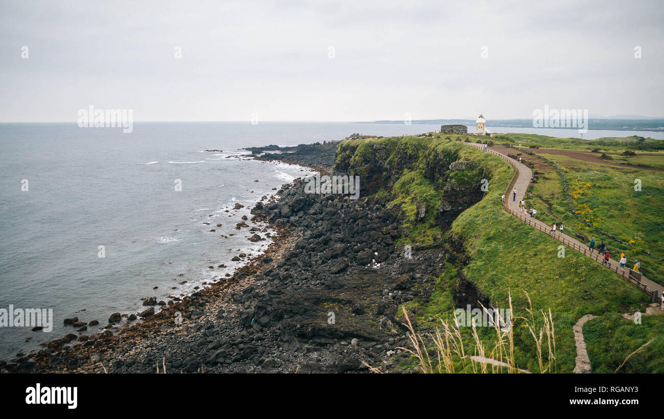 Ocean view with volcanic rock on the beach in the Seogwipo area of ...