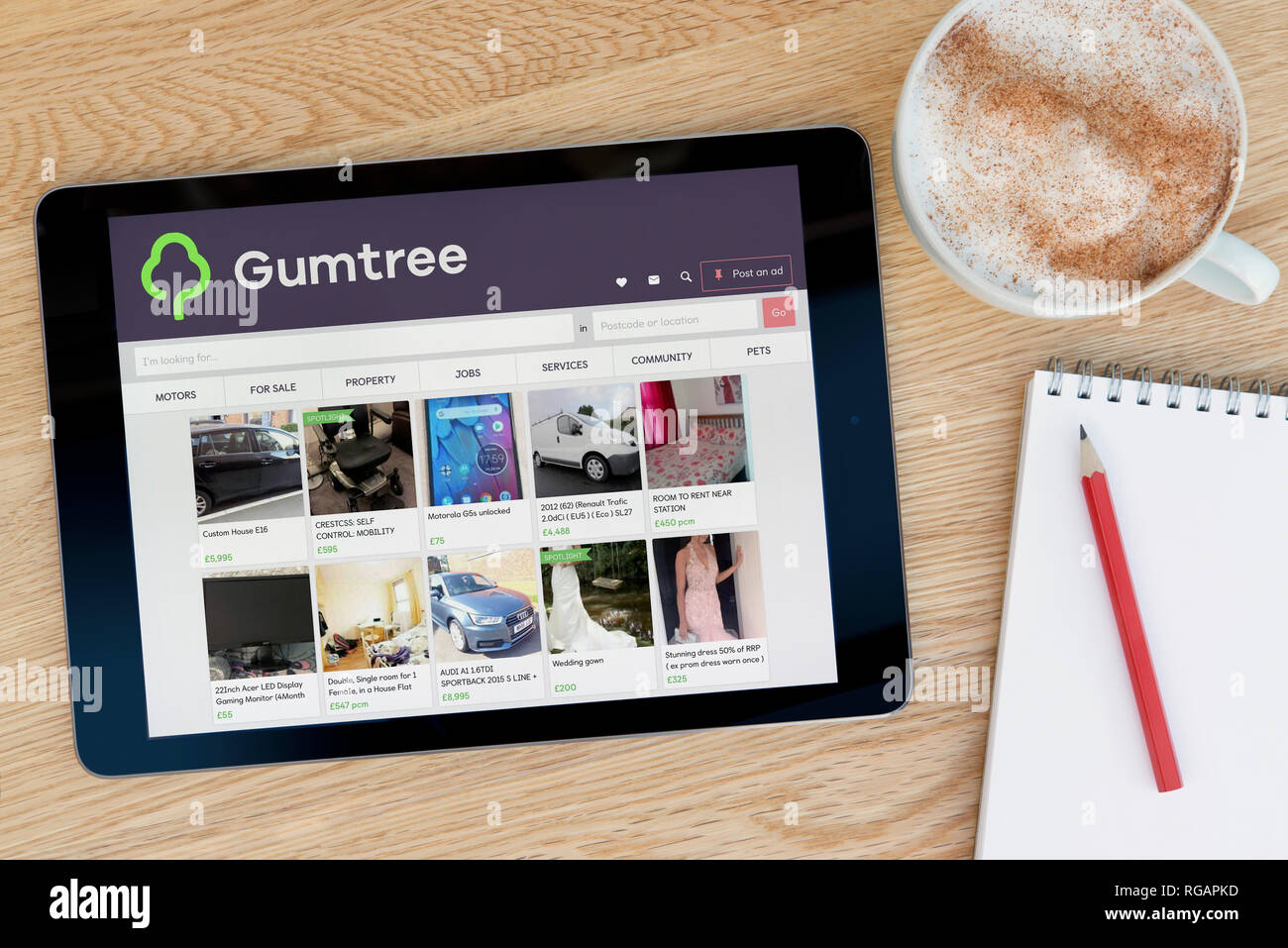 The Gumtree website features on an iPad tablet device which rests on a ...