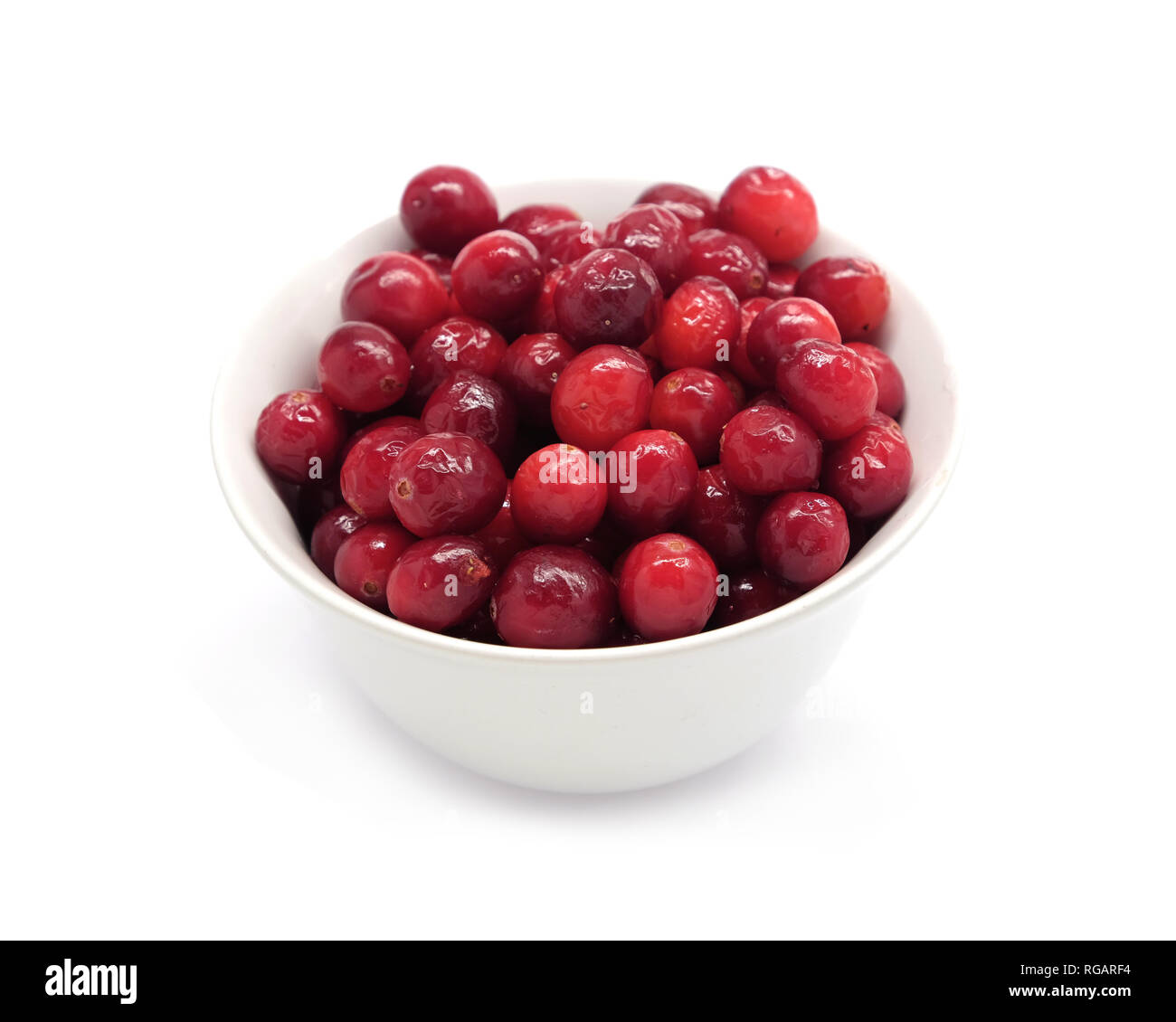 Cranberries in round white bowl isolated on white background indoor ...