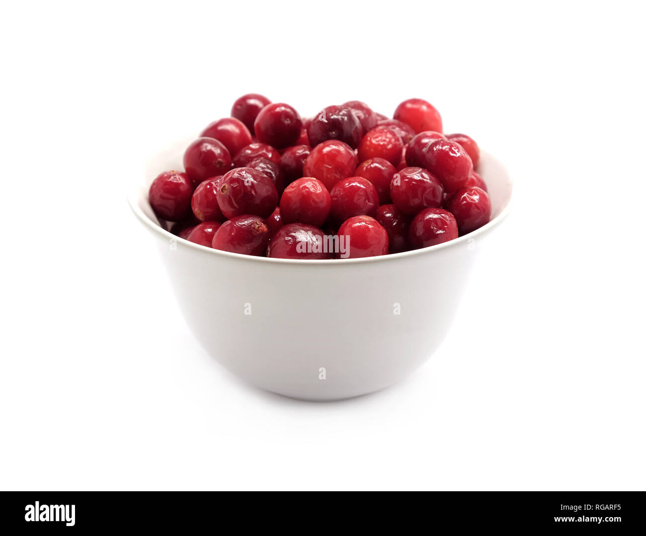 Cranberries in round white bowl isolated on white background indoor ...