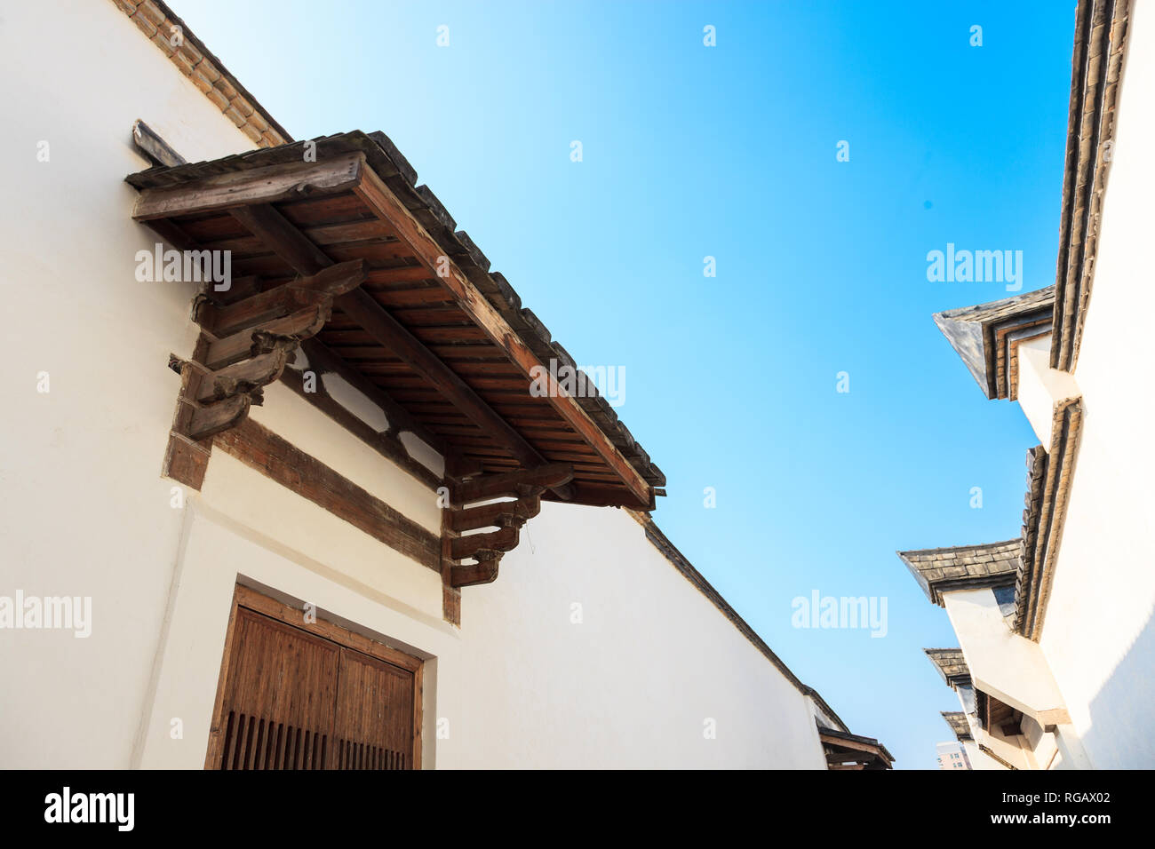 Two row of The traditional Chinese roof and wall against a blue sky ...
