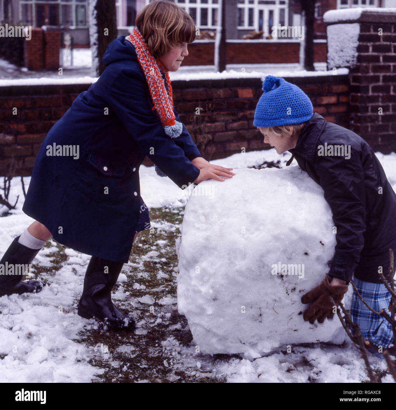 Two children.a boy with an older girl,arguing about which way to push a ...