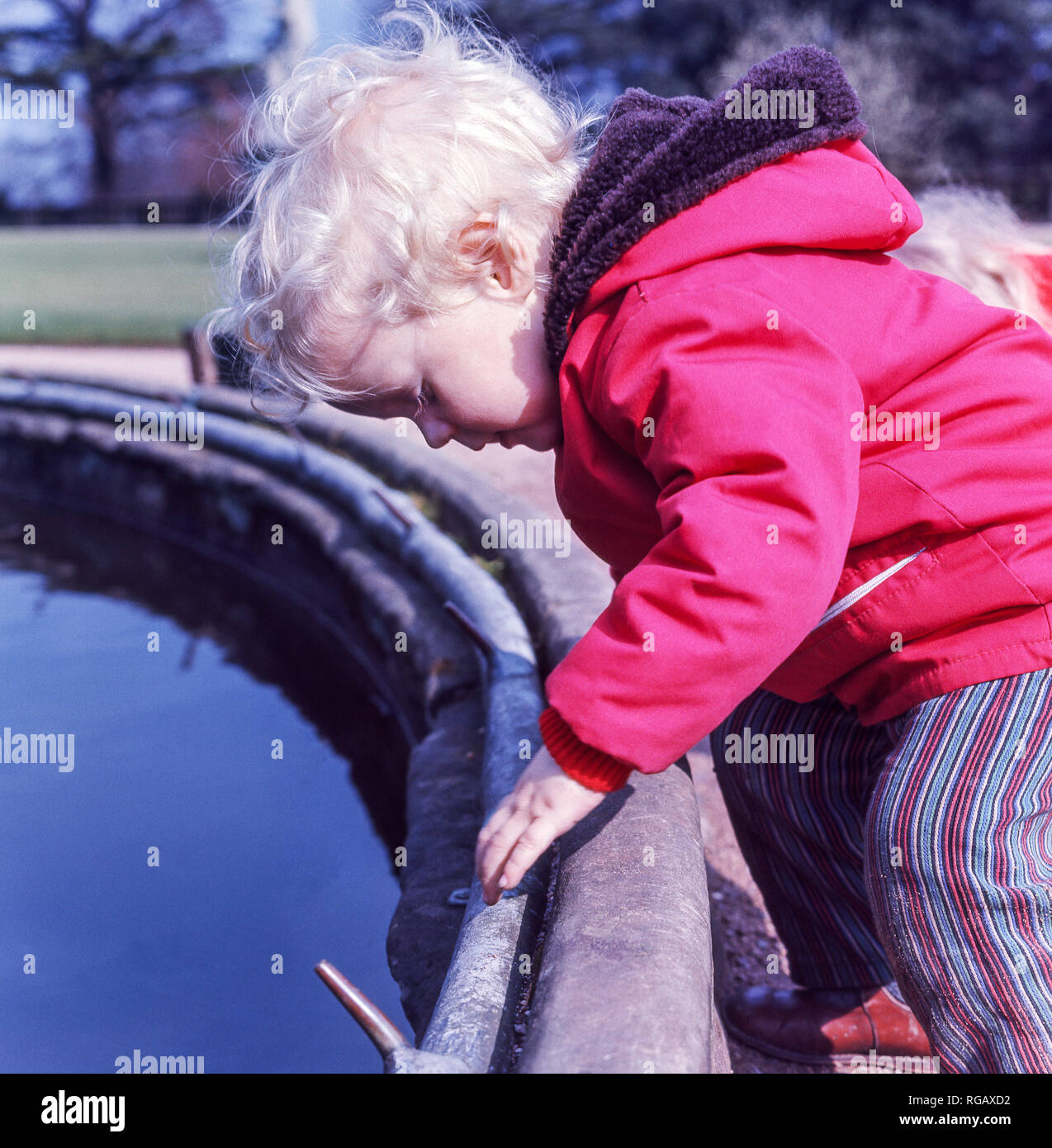 Young boy exploring water Stock Photo - Alamy