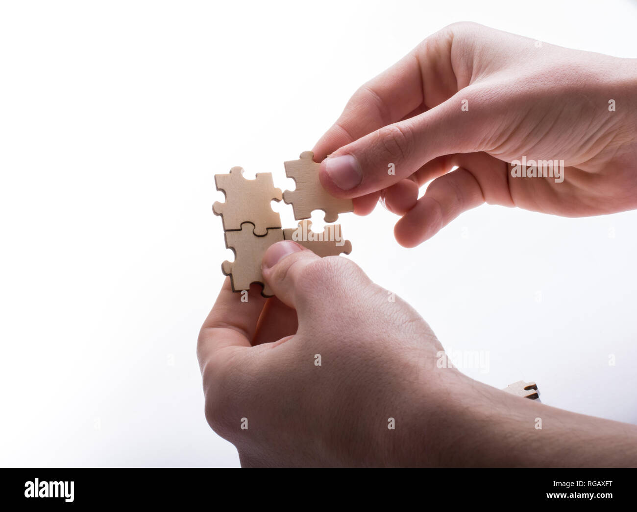 Hand completing a puzzle group on a white background Stock Photo - Alamy