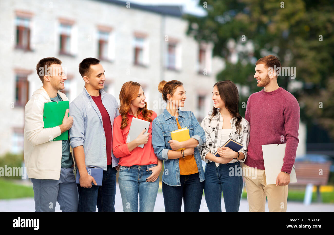 group of smiling students talking over campus Stock Photo - Alamy
