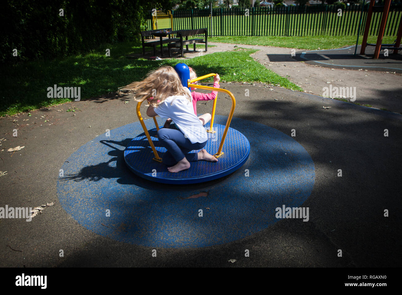 Girls on roundabout hi-res stock photography and images - Alamy