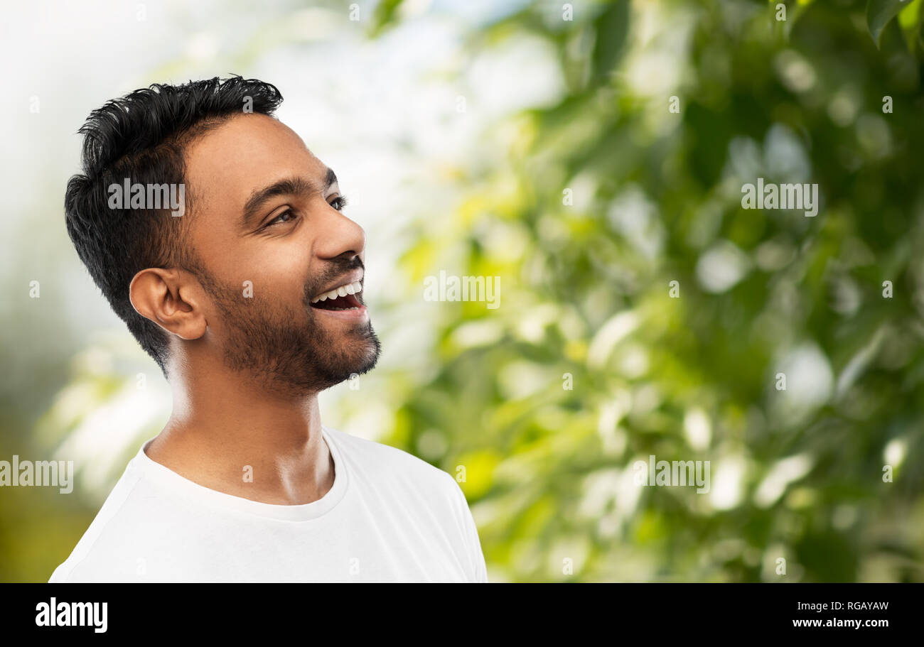 young laughing indian man over natural background Stock Photo - Alamy