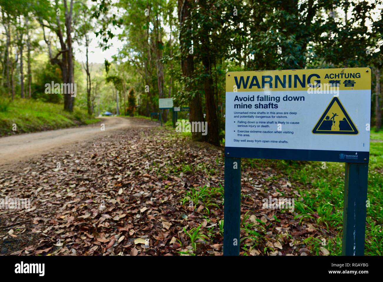 Warning avoid falling down mine shafts sign, Bush camp at The Diggings ...