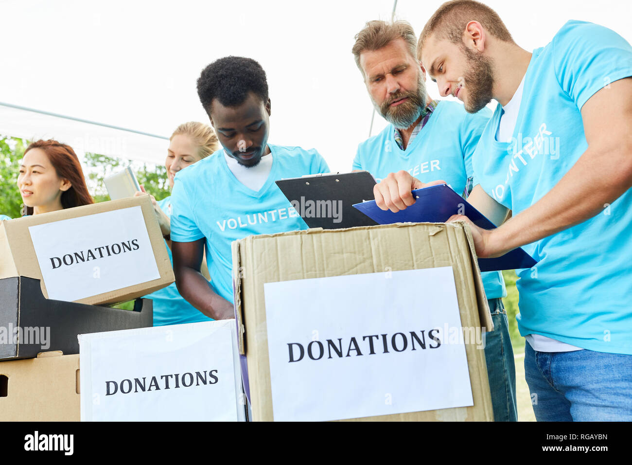 Volunteers in volunteer with donation boxes for a social project Stock ...