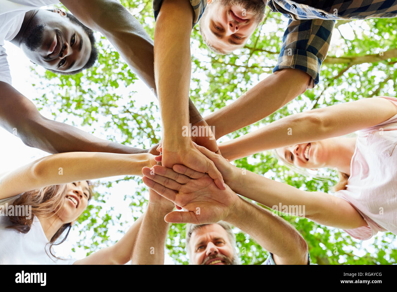 Team stacks hands in a workshop for teambuilding and teambuilding Stock ...
