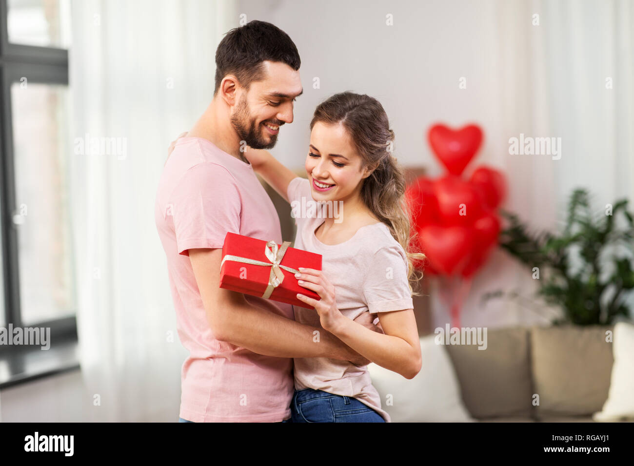 Gift box hugging hi-res stock photography and images - Alamy