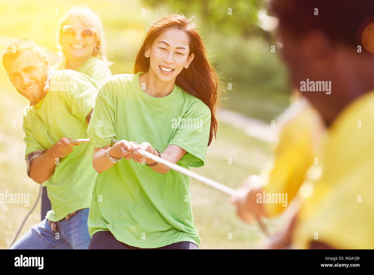 People pull together as a team in tug-of-war Stock Photo - Alamy
