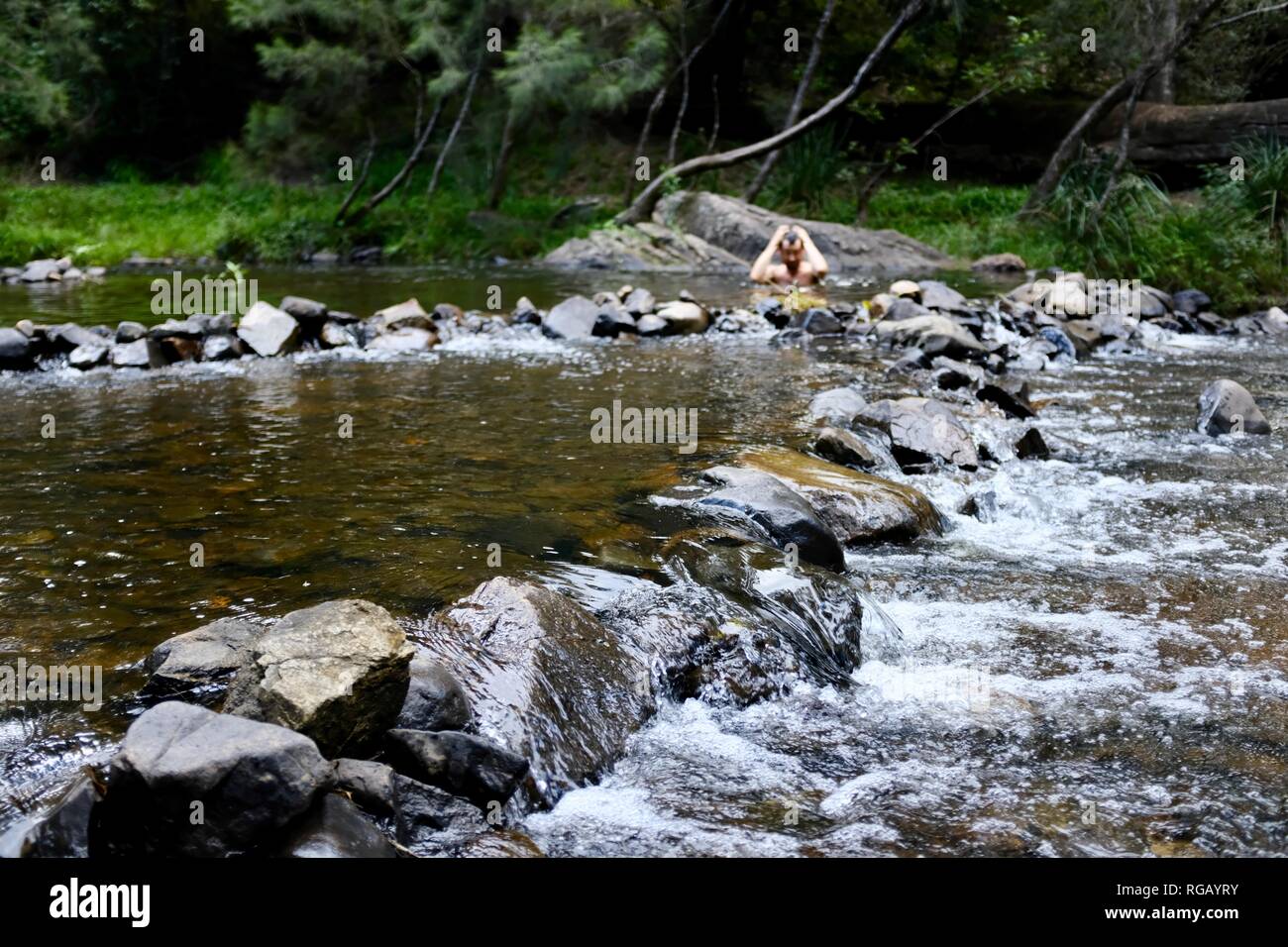 A man refreshes in Broken river, at the Bush camp at The Diggings ...