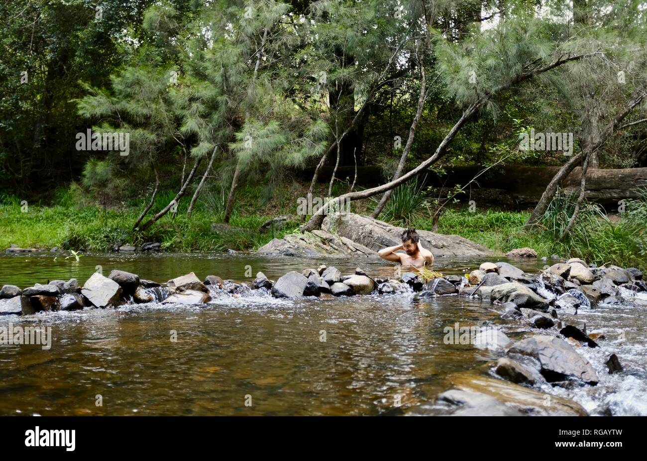 A man refreshes in Broken river, at the Bush camp at The Diggings ...
