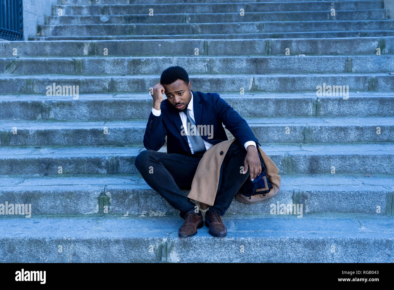 Young fired african american business man lost in depression crying ...