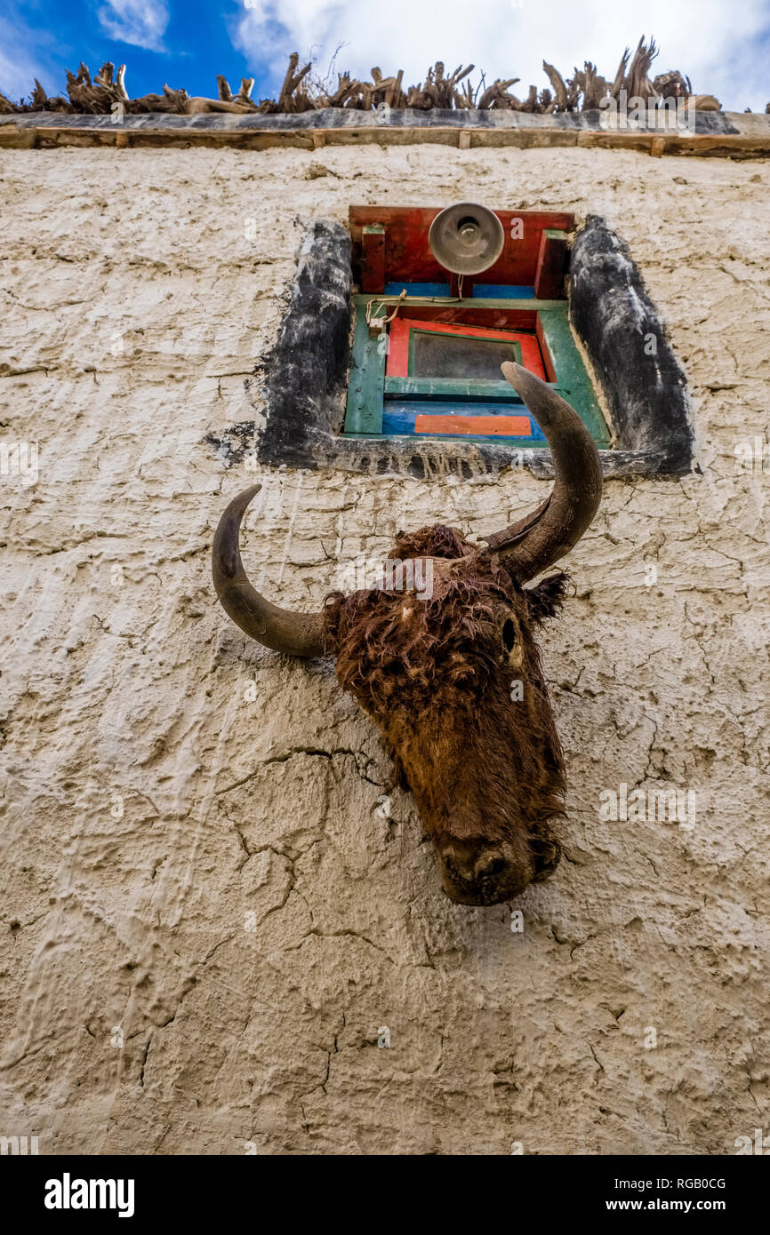 White painted facade of a traditional house inside the walled town with ...