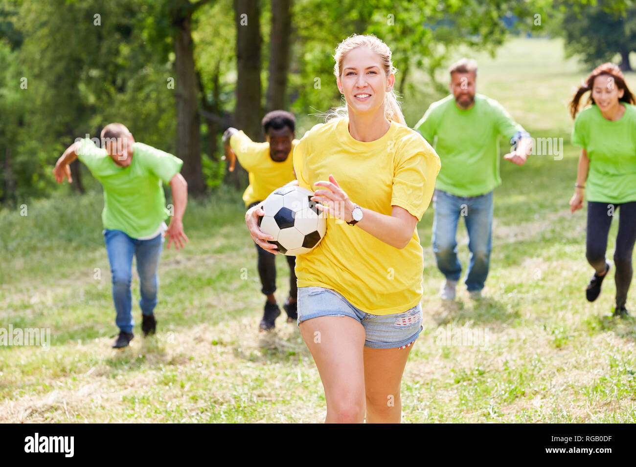 Woman is running a ball in a competition at the teambuilding workshop ...