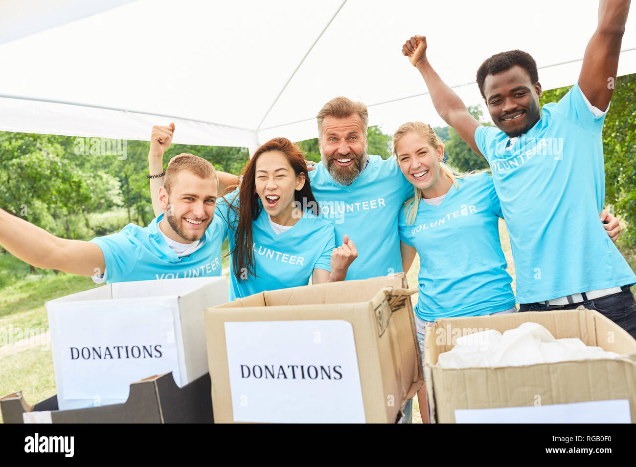 Volunteer volunteers cheer at a charitable fundraiser Stock Photo - Alamy