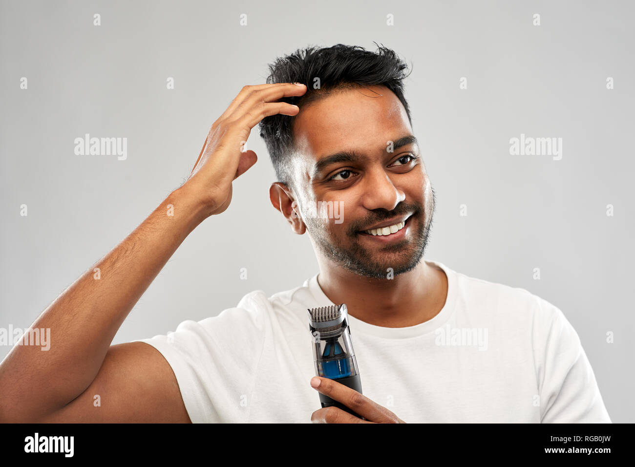 Indian man styling hair hi-res stock photography and images - Alamy