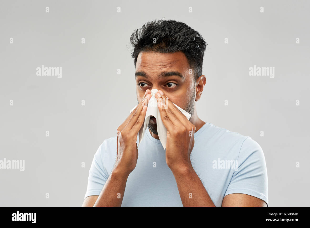 indian man with paper napkin blowing nose Stock Photo - Alamy