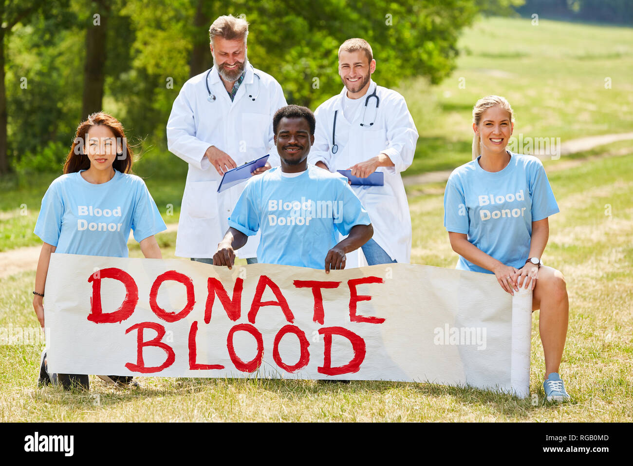 Group volunteers with poster make a call for blood donation Stock Photo ...