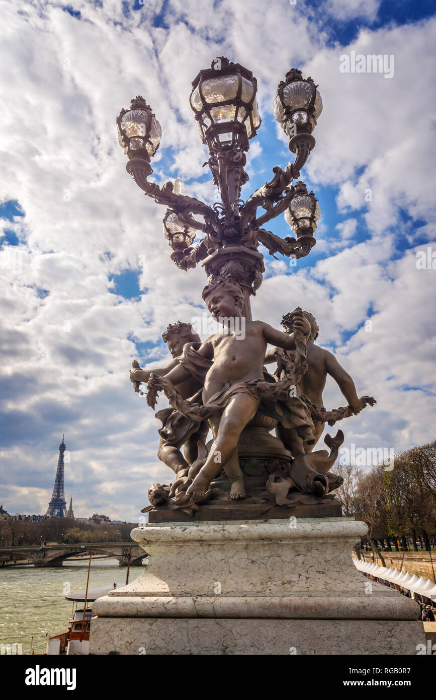 Street lamp from year 1900 on bridge Alexandre III, the river Seine and ...