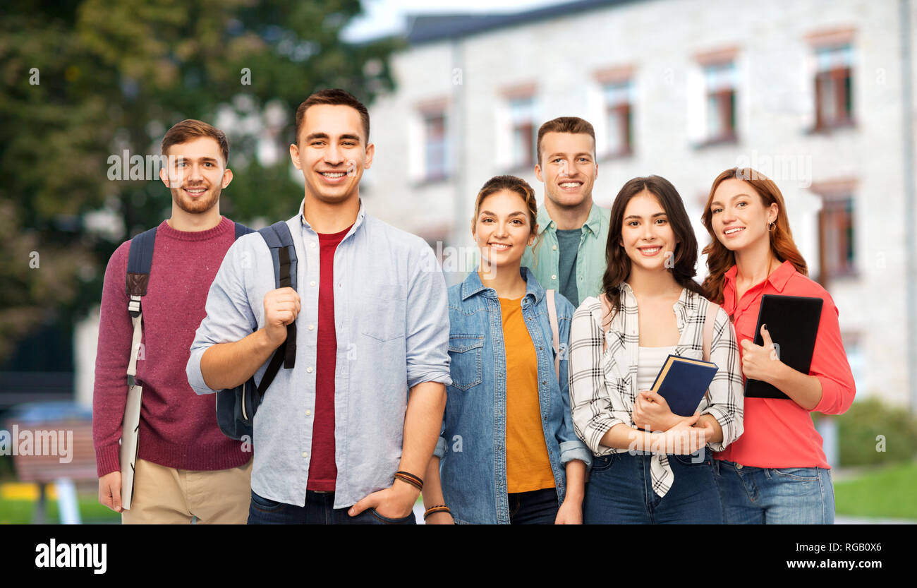 group of smiling students with books over campus Stock Photo - Alamy
