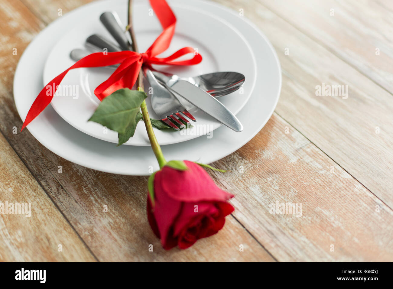 close up of red rose flower on set of dishes Stock Photo - Alamy