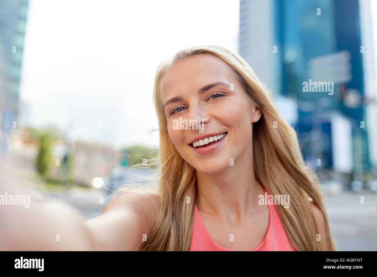 happy young woman taking selfie on city street Stock Photo - Alamy
