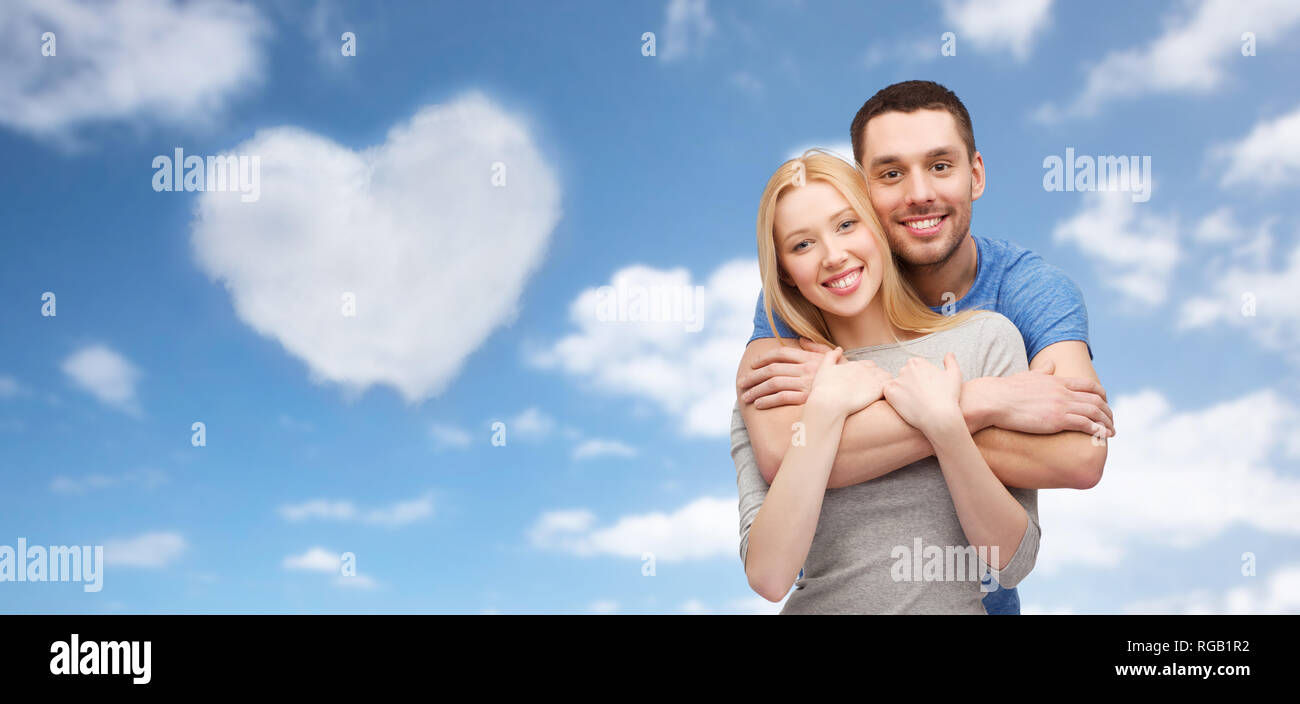 couple hugging over sky and heart shaped cloud Stock Photo - Alamy