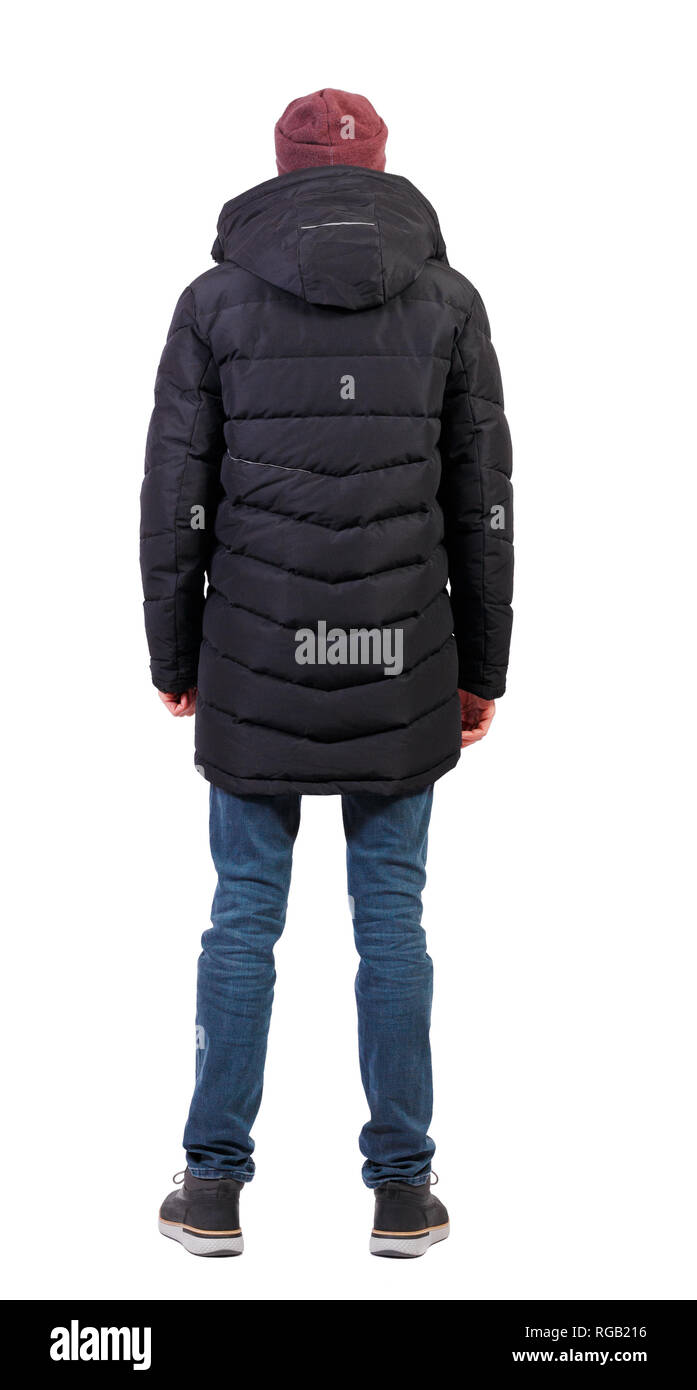 Back view of handsome man In long black jacket with a hood. Standing ...