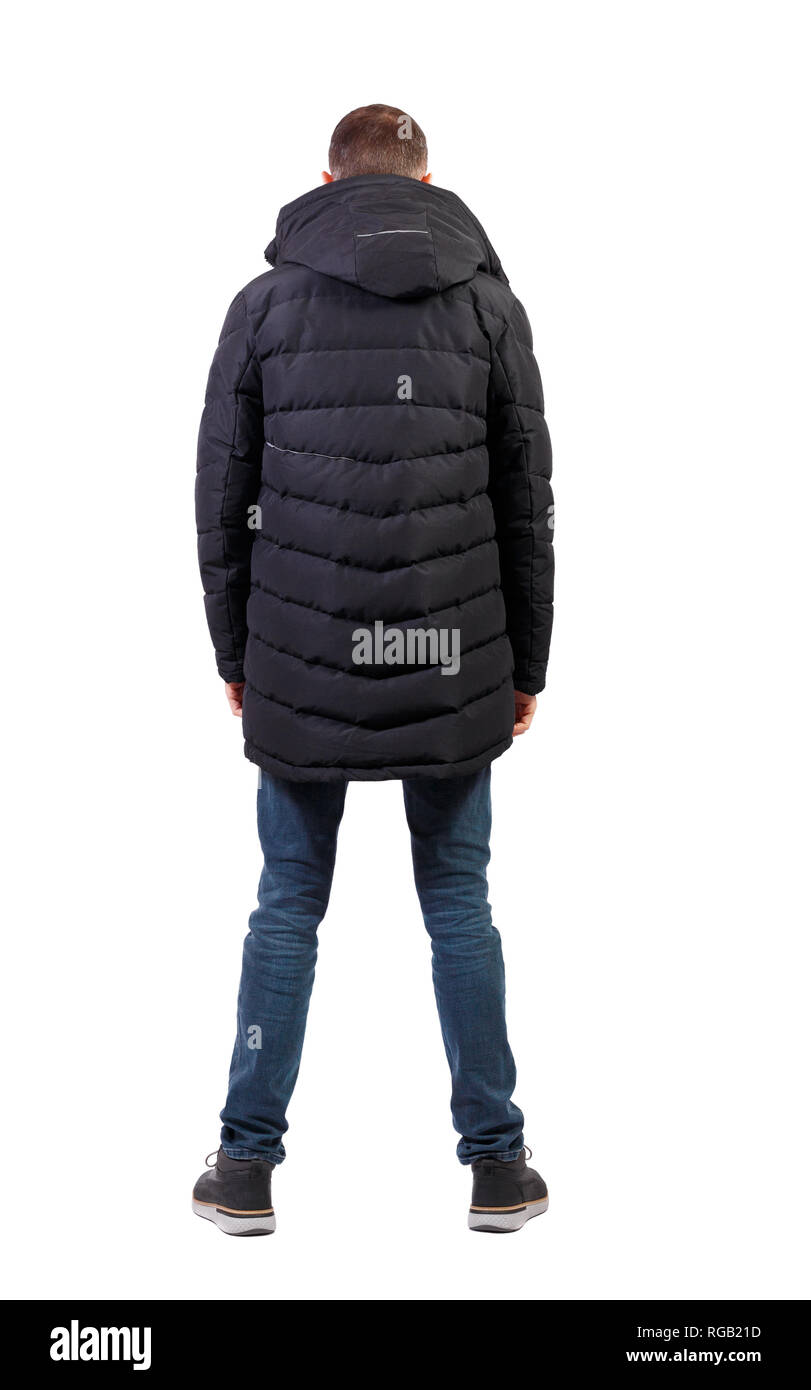 Back view of handsome man In long black jacket with a hood. Standing ...