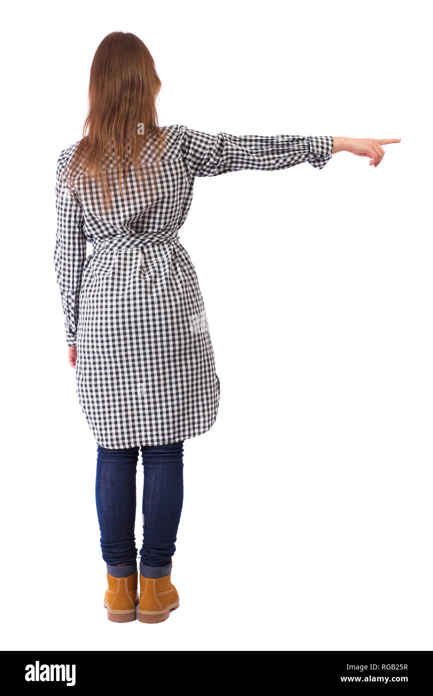 Back view of a woman in a sweater points his hand upwards. Rear view ...