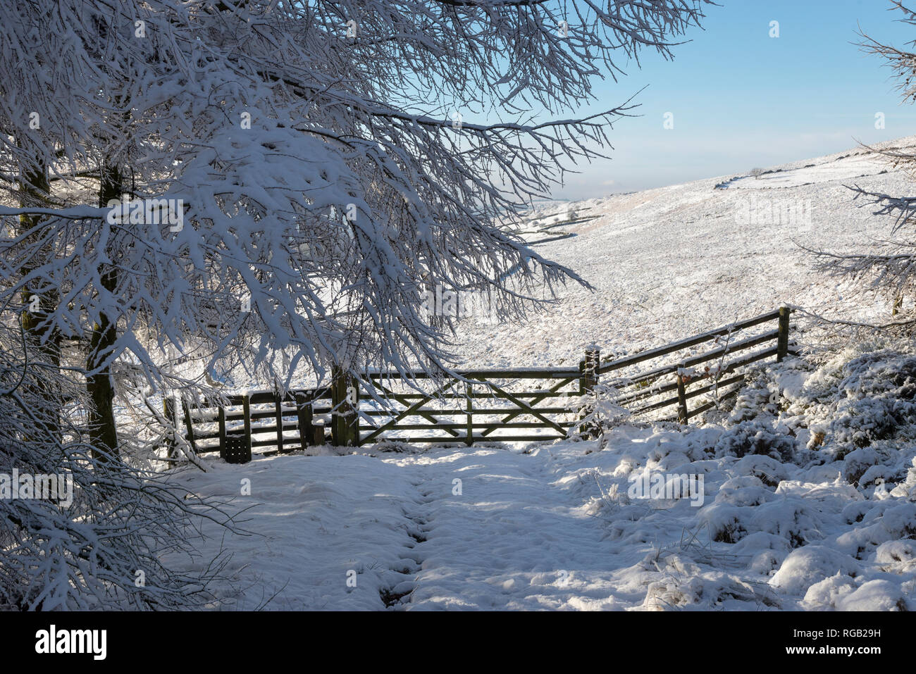 Gate in a snowy winter landscape in the hills of Northern England. Path ...