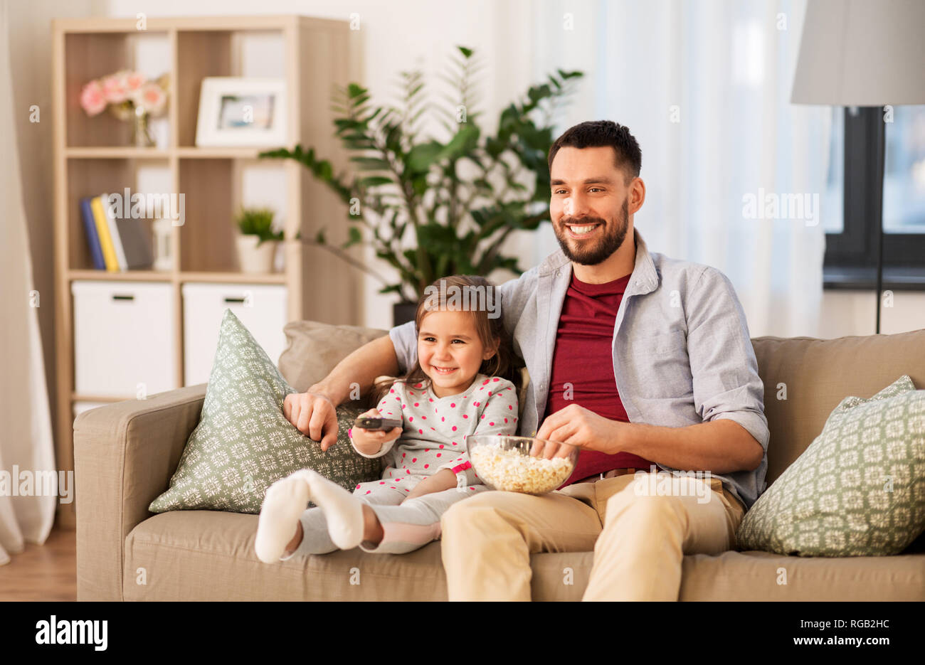 happy father and daughter watching tv at home Stock Photo - Alamy