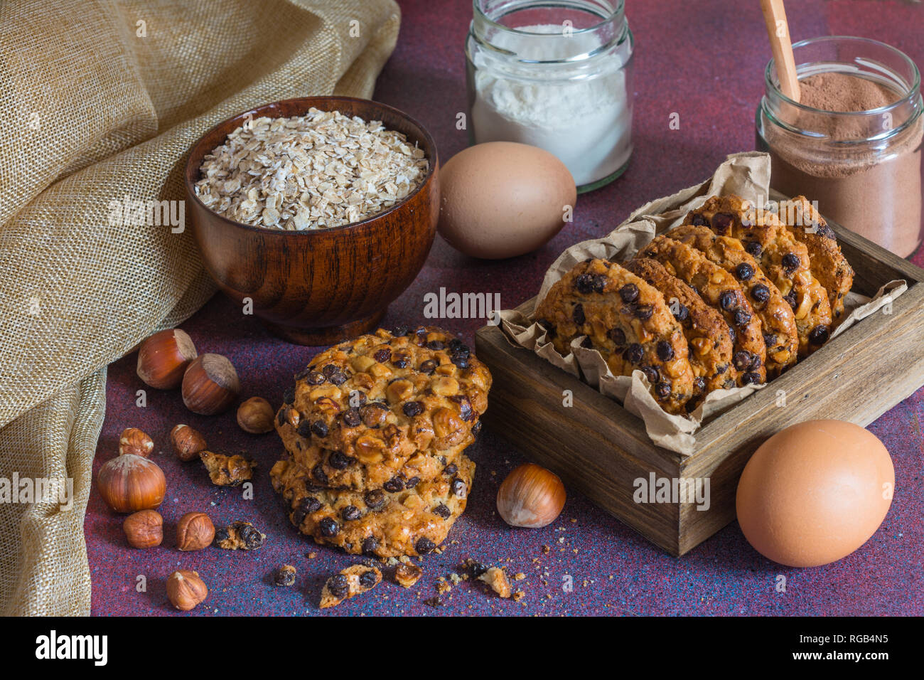 Box with avena cookies with hazelnuts and chocolate chips, a bowl with ...