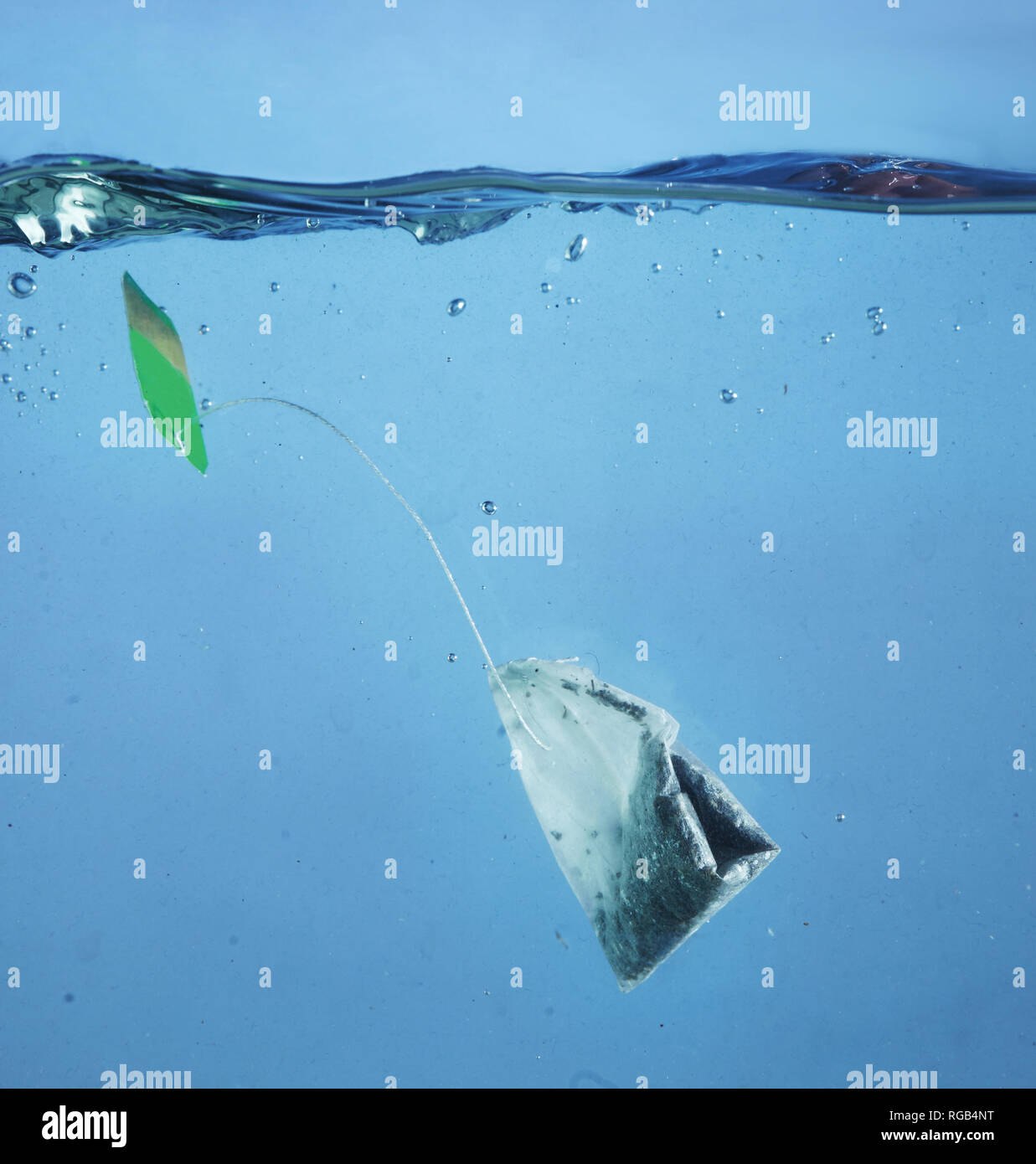 tea bag as a symbol of pollution in the ocean Stock Photo - Alamy