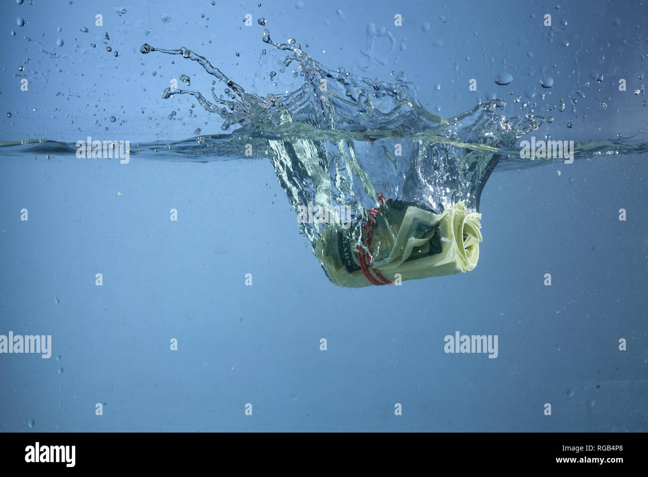 US Dollar sinking in water as symbol of global financiall crisis and ...