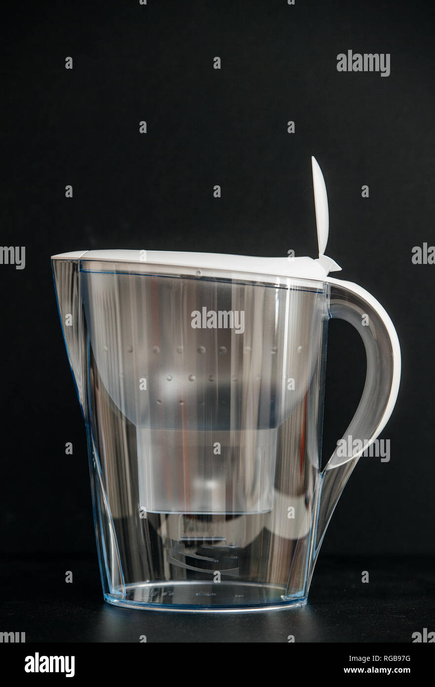 New water filter with opened plastic lid against black background Stock ...