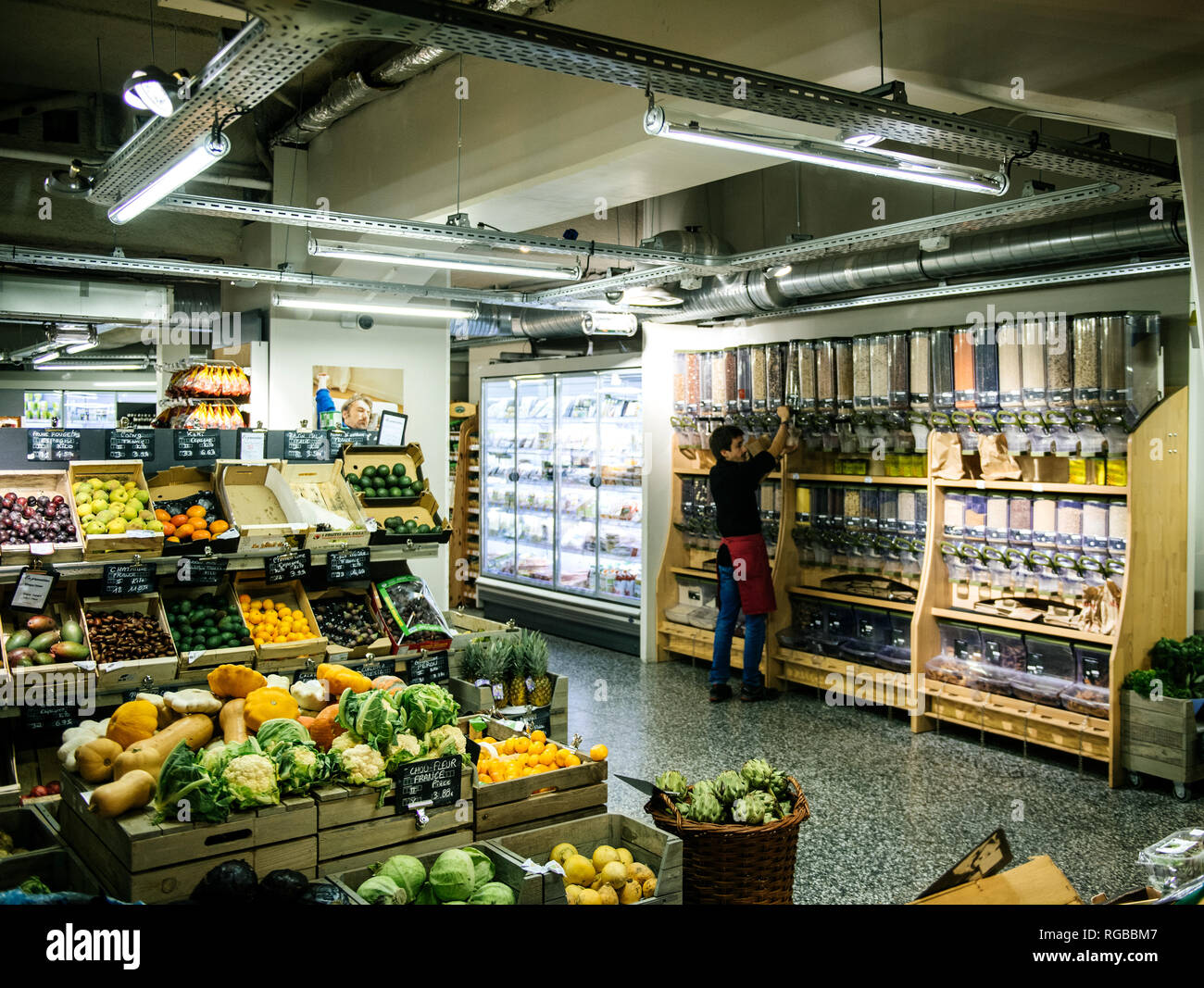 PARIS, FRANCE - OCT 13, 2017: Worker inside interior store arranging ...