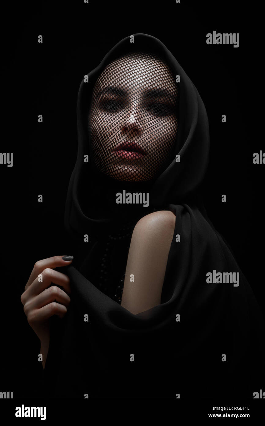 serious female beautiful face with stocking on head looking at camera ...