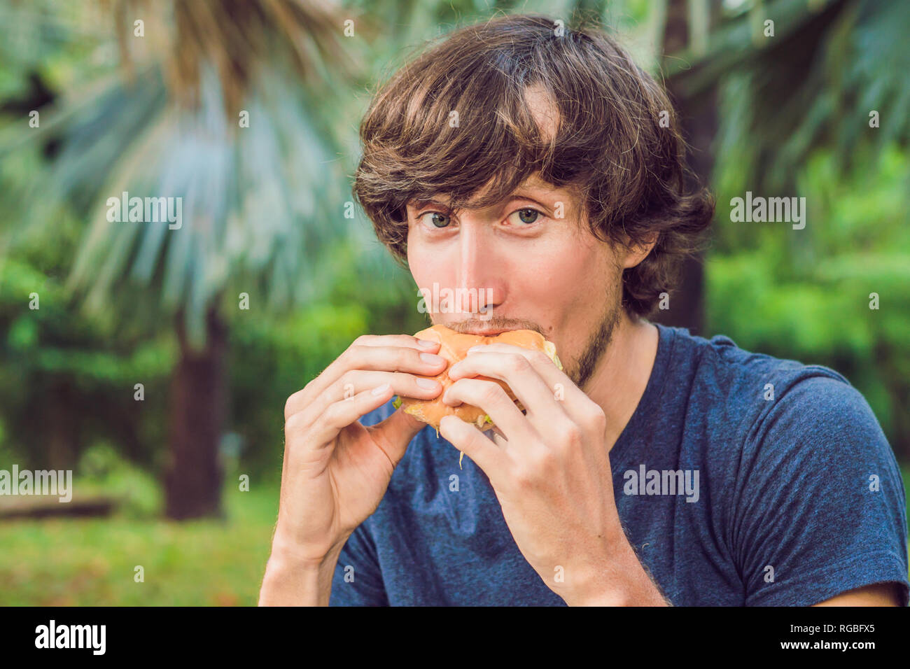 Young man eating sandwich salad hi-res stock photography and images - Alamy