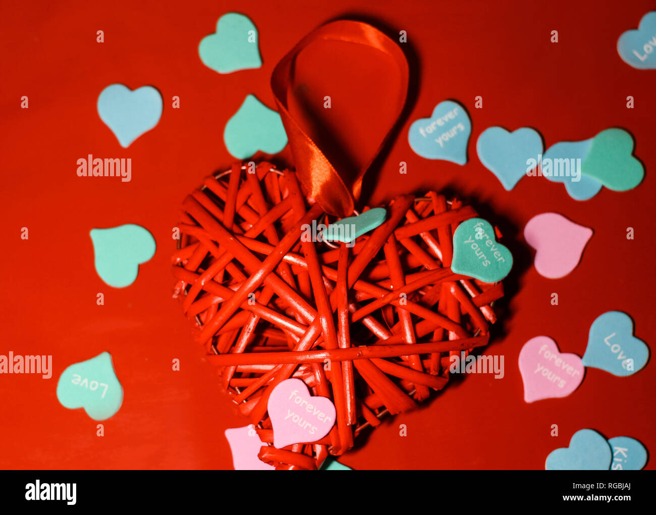 Beautiful red heart closeup with decorations from multi-colored hearts ...