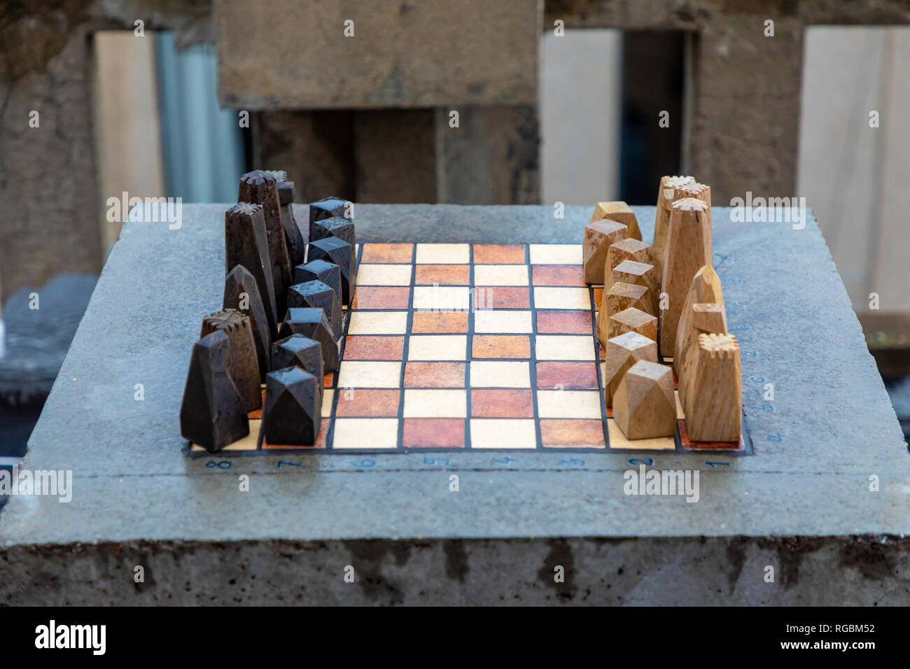 A set of stone handmade wooden chess on stone table in home outdoor ...