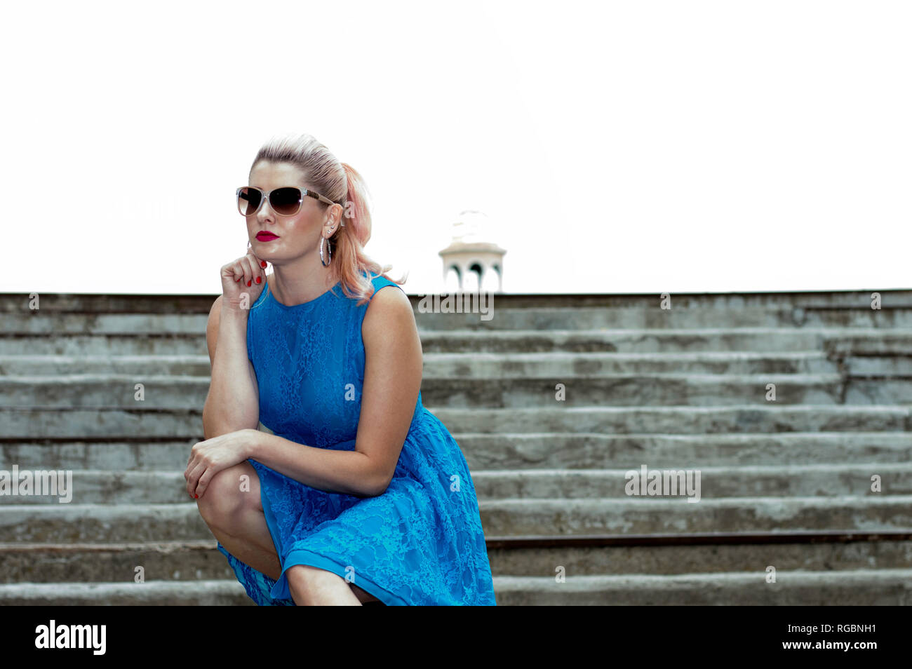 woman in the blue dress sat on the steps, the theme of beautiful ...